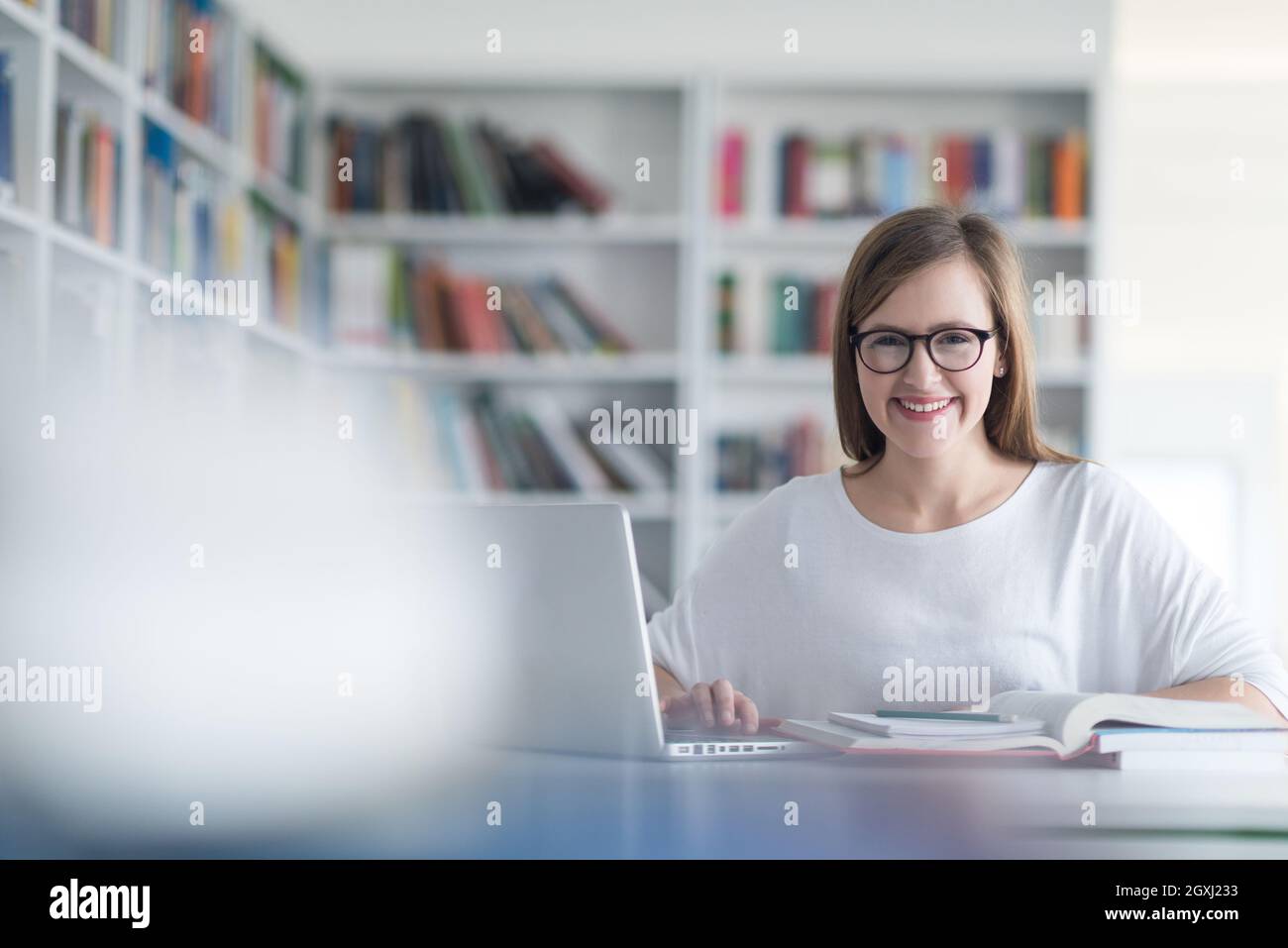 female student study in school library, using laptop and searching for ...
