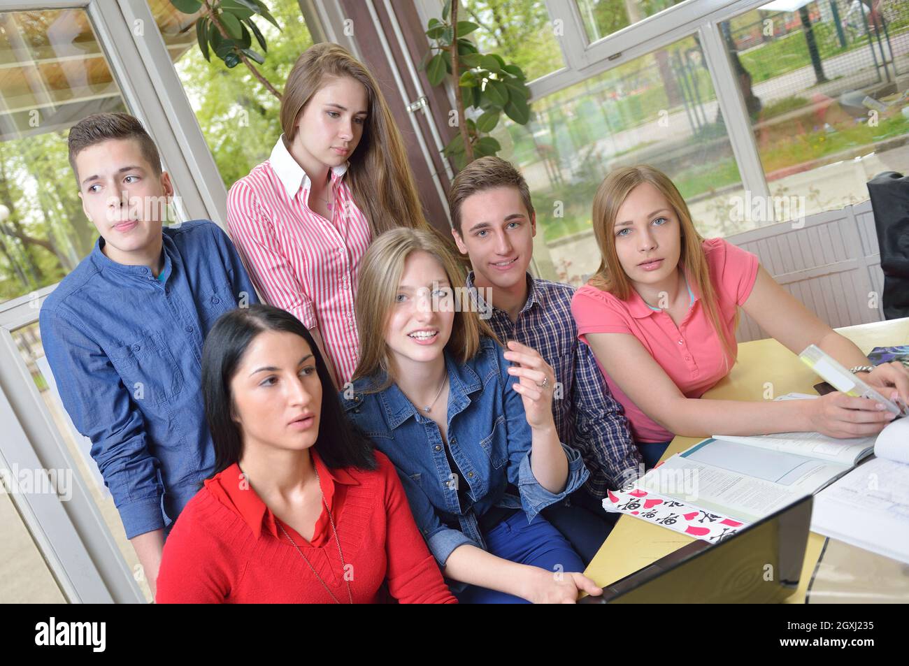 happy young teens group in school have fun an learning lessons Stock ...