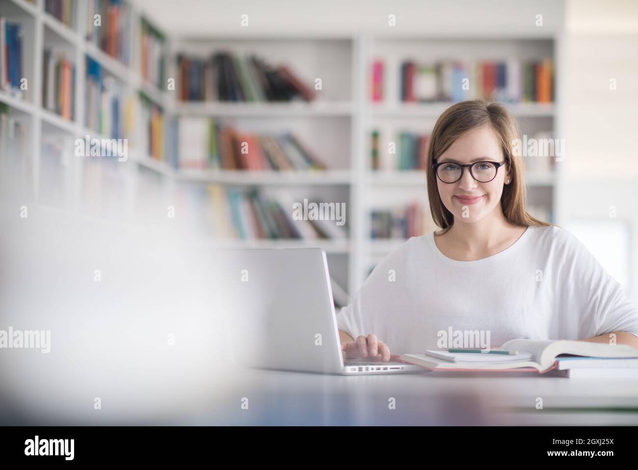female student study in school library, using laptop and searching for ...