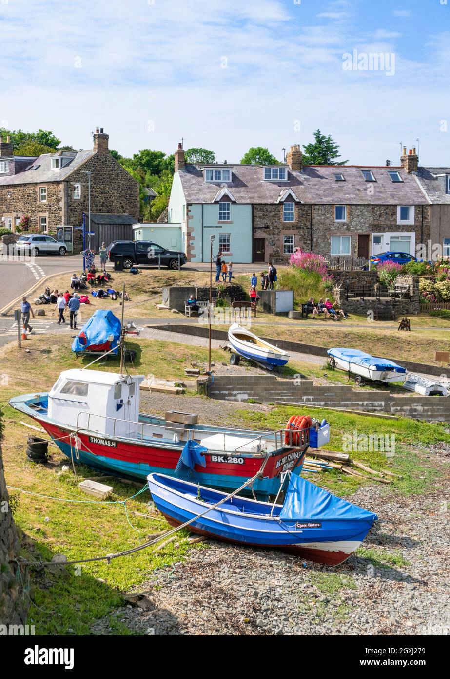 Fishing boats in the harbour in the coastal village of Craster Village ...