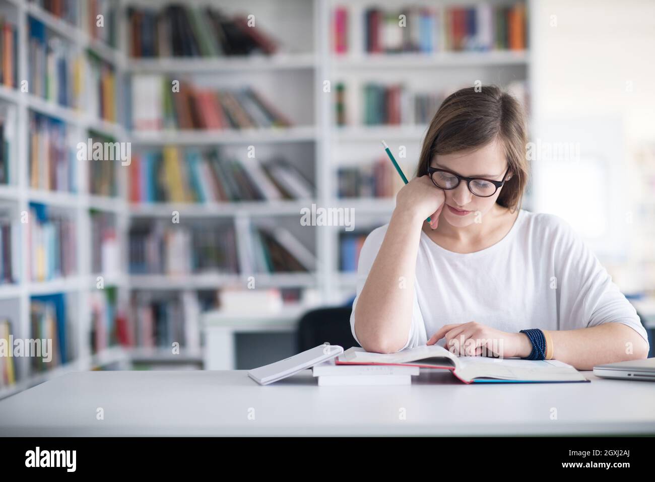female student study in school library, using laptop and searching for ...
