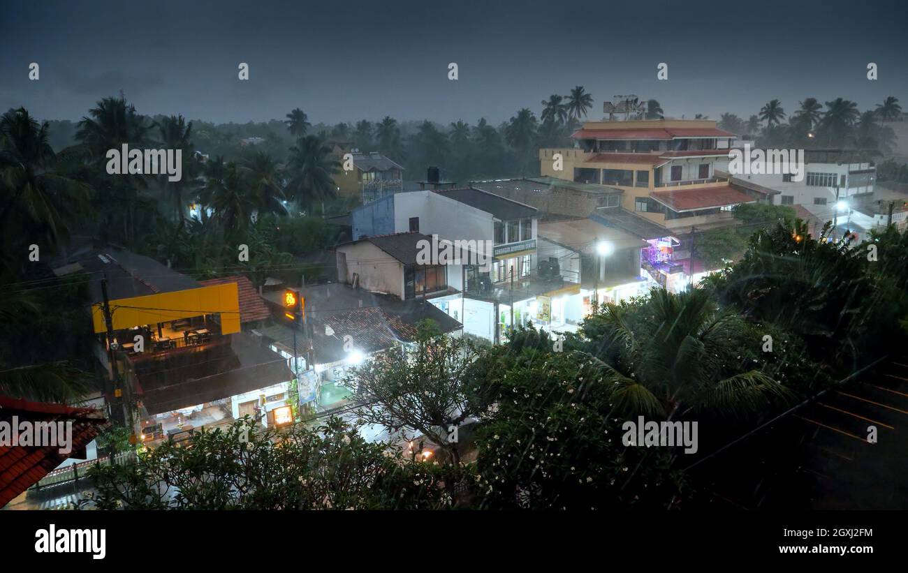 Photo of heavy seasonal tropical rain over small asian town on tropical ...