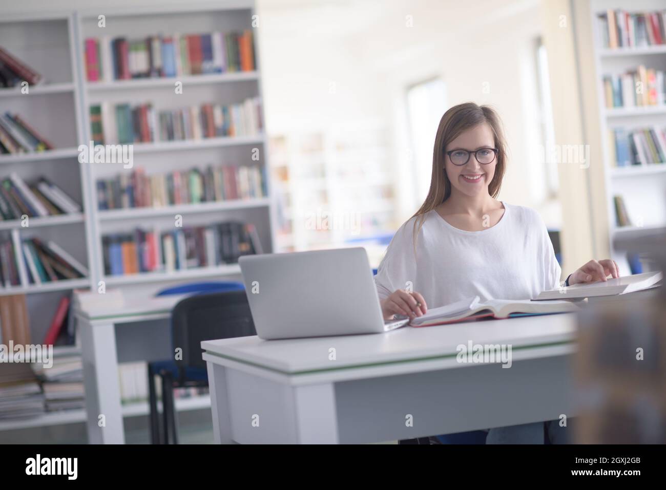 female student study in school library, using laptop and searching for ...