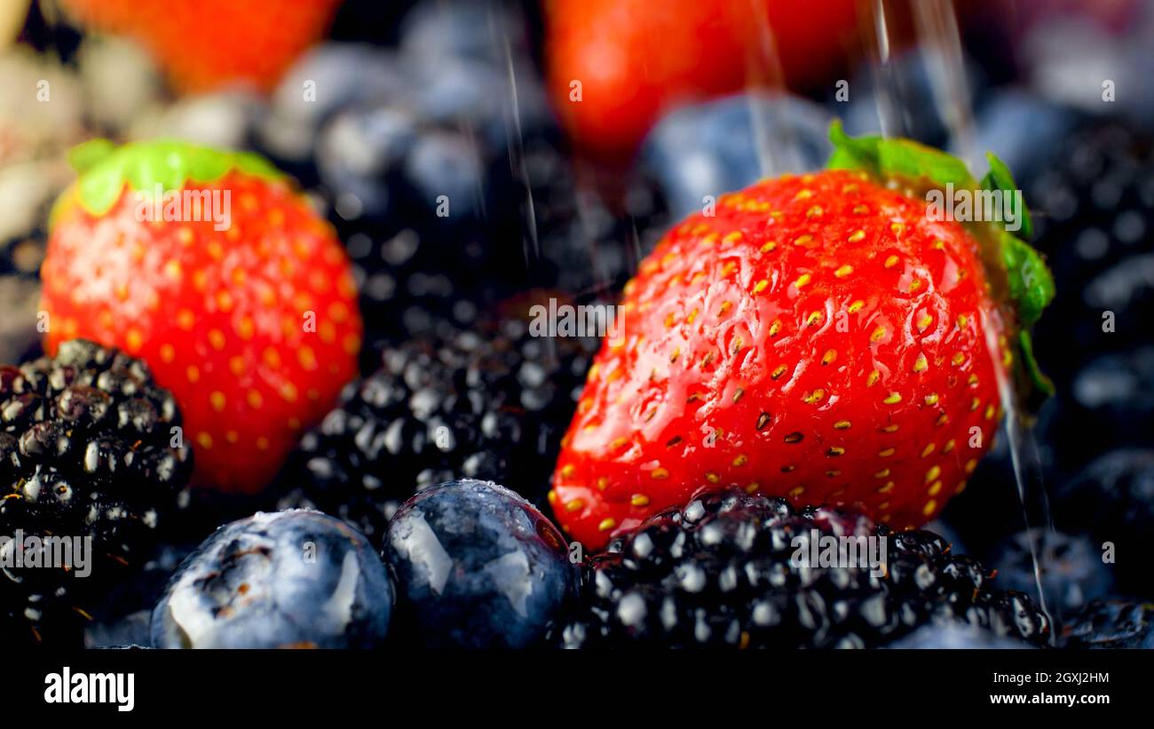 Macro photo of water dropelts falling on fresh strawberries ...