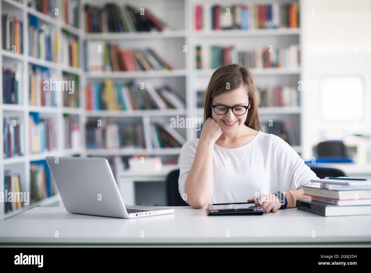female student study in school library, using laptop and searching for ...
