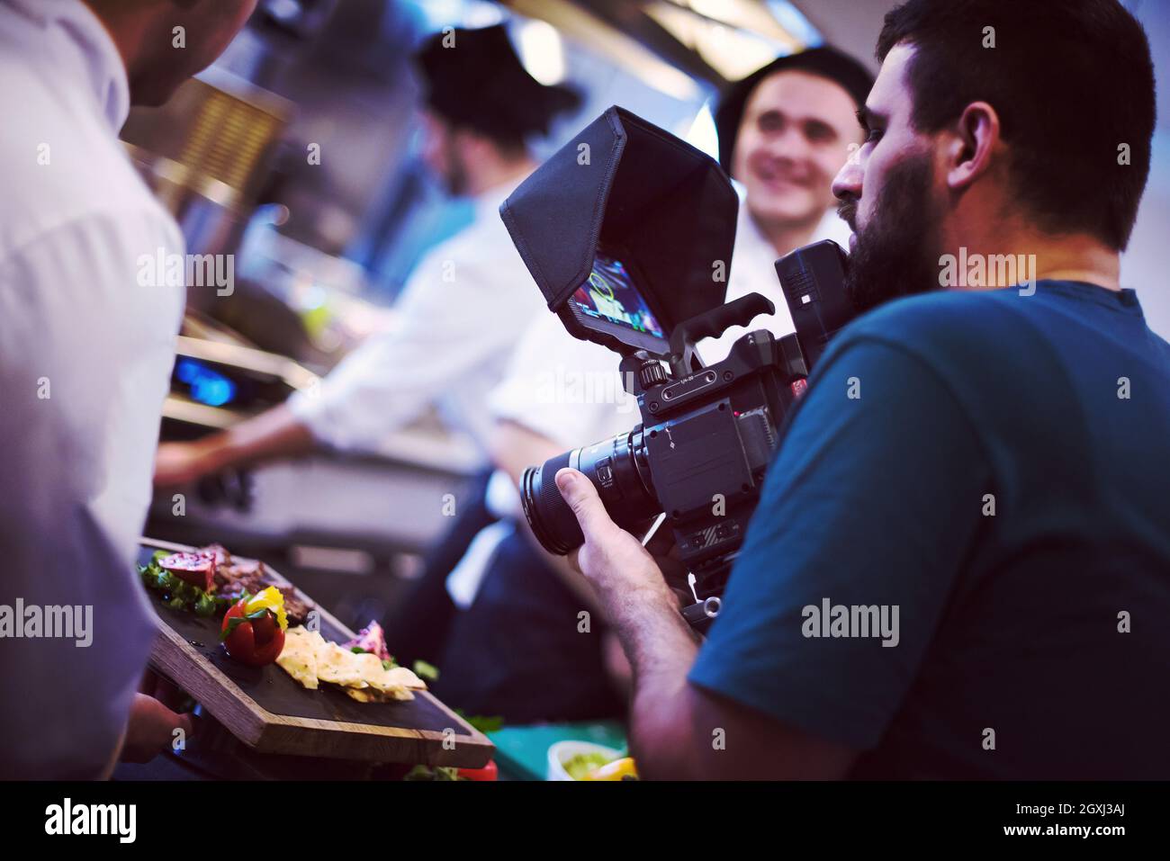 videographer recording while Professional team cooks and chefs ...