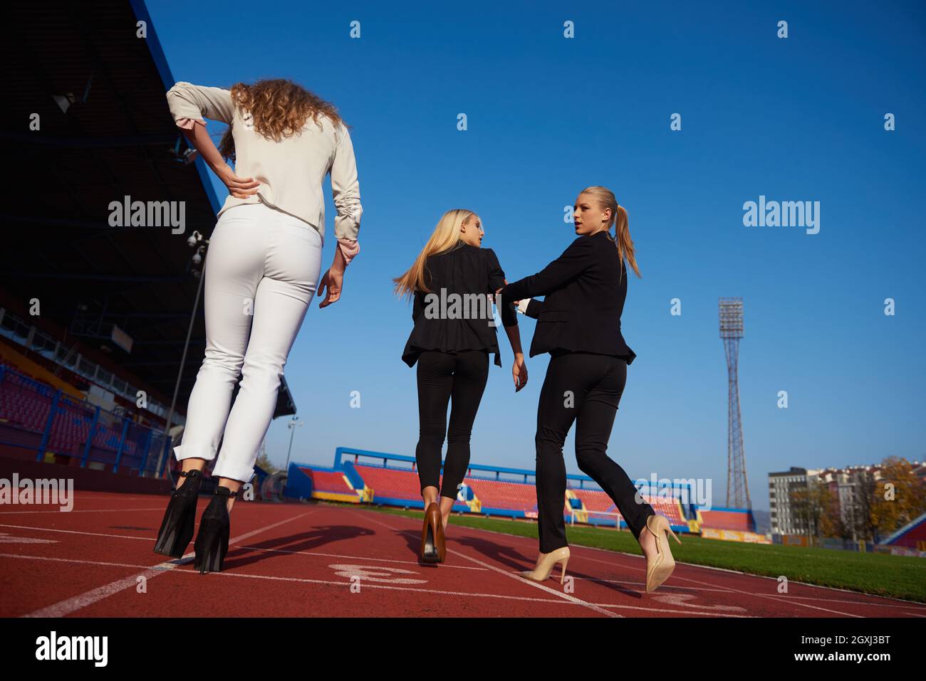business people running together on racing track Stock Photo - Alamy