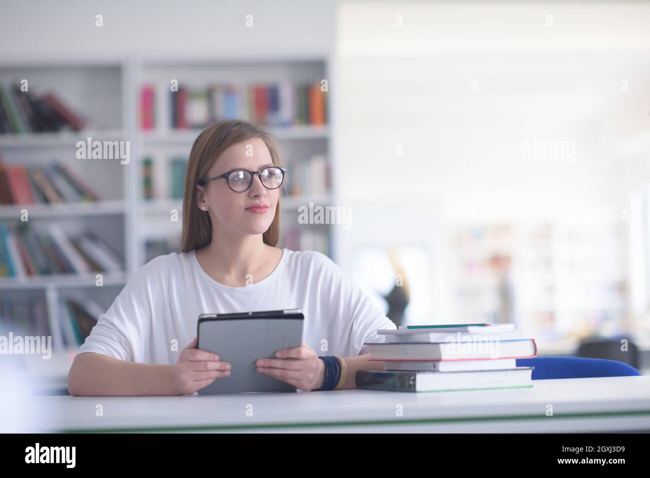 female student study in school library, using tablet and searching for ...