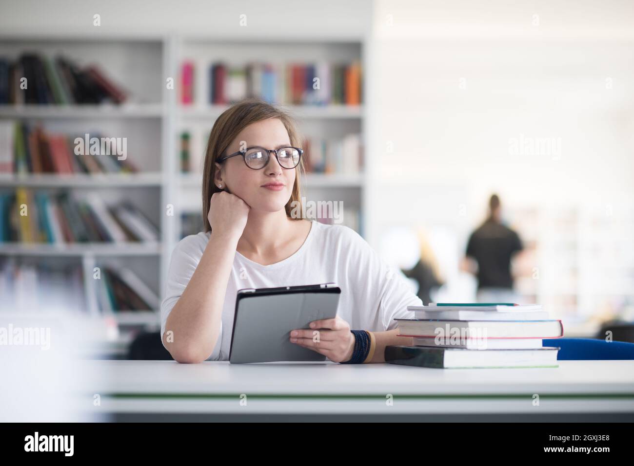 female student study in school library, using tablet and searching for ...