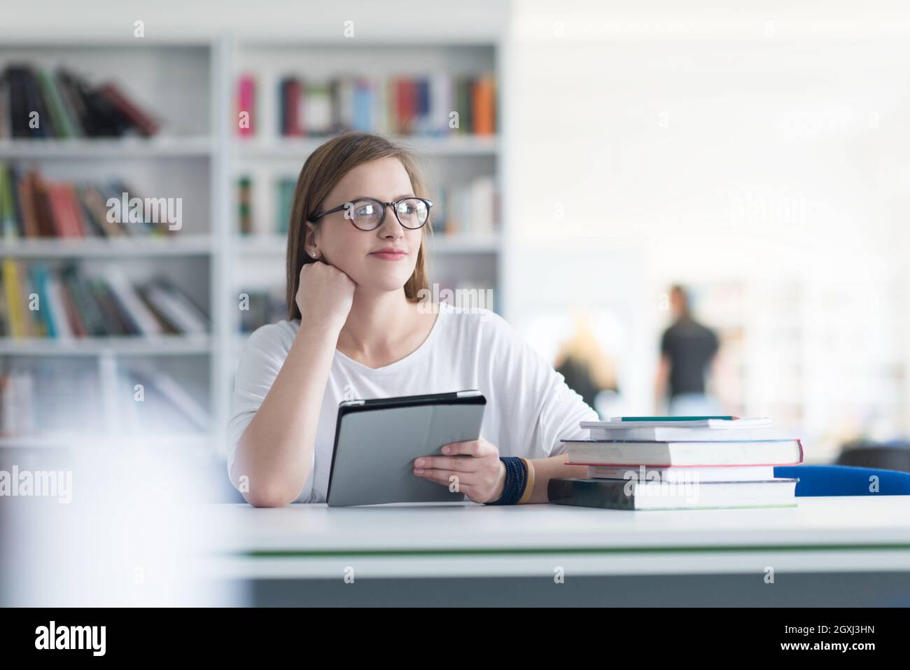 female student study in school library, using tablet and searching for ...