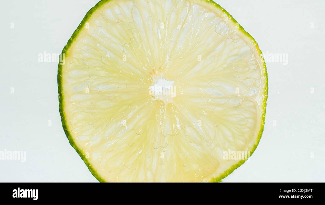 Macro image of ripe tasty lime slice on white background. Abstract ...