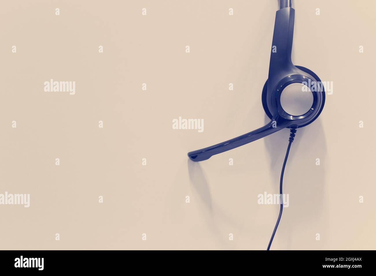 Headphones hanging on cubicle partition in empty call center office ...