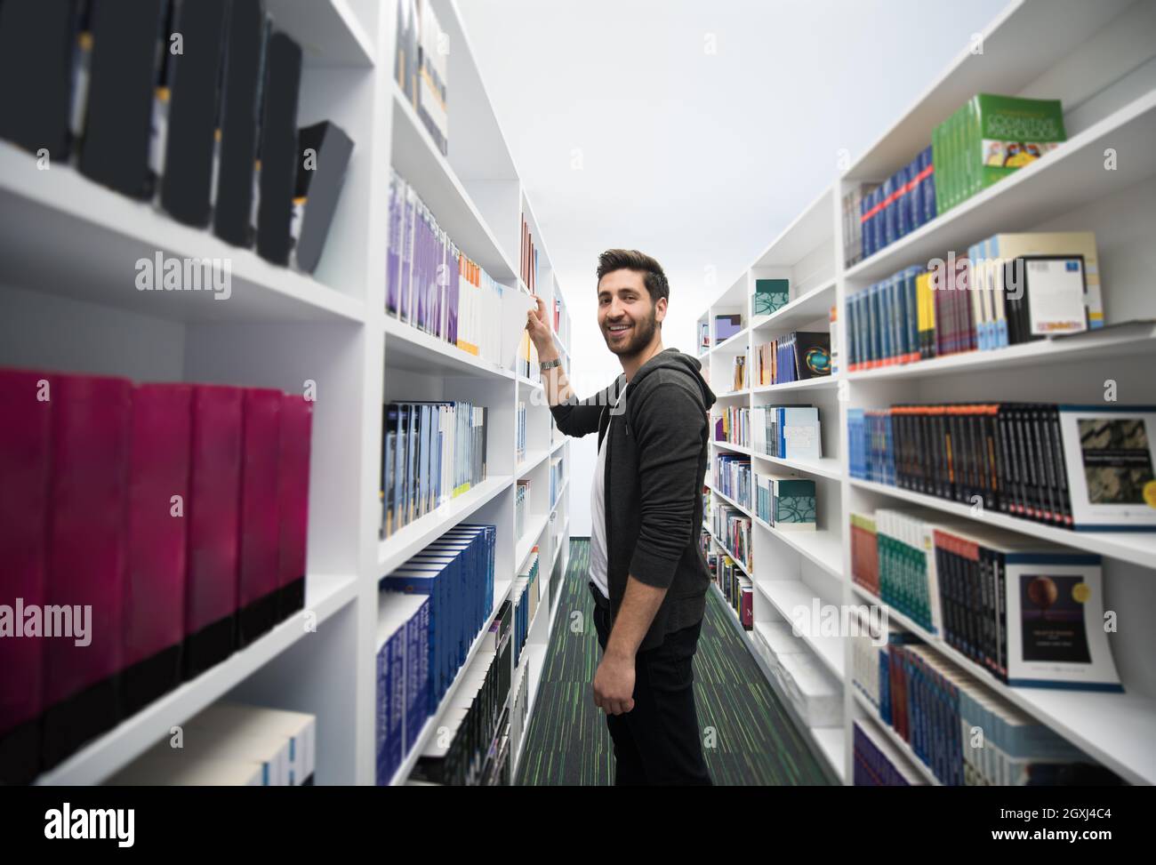 Student reading book in school library. Study lessons for exam. Hard ...
