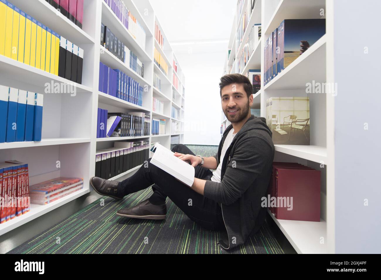 Student reading book in school library. Study lessons for exam. Hard ...