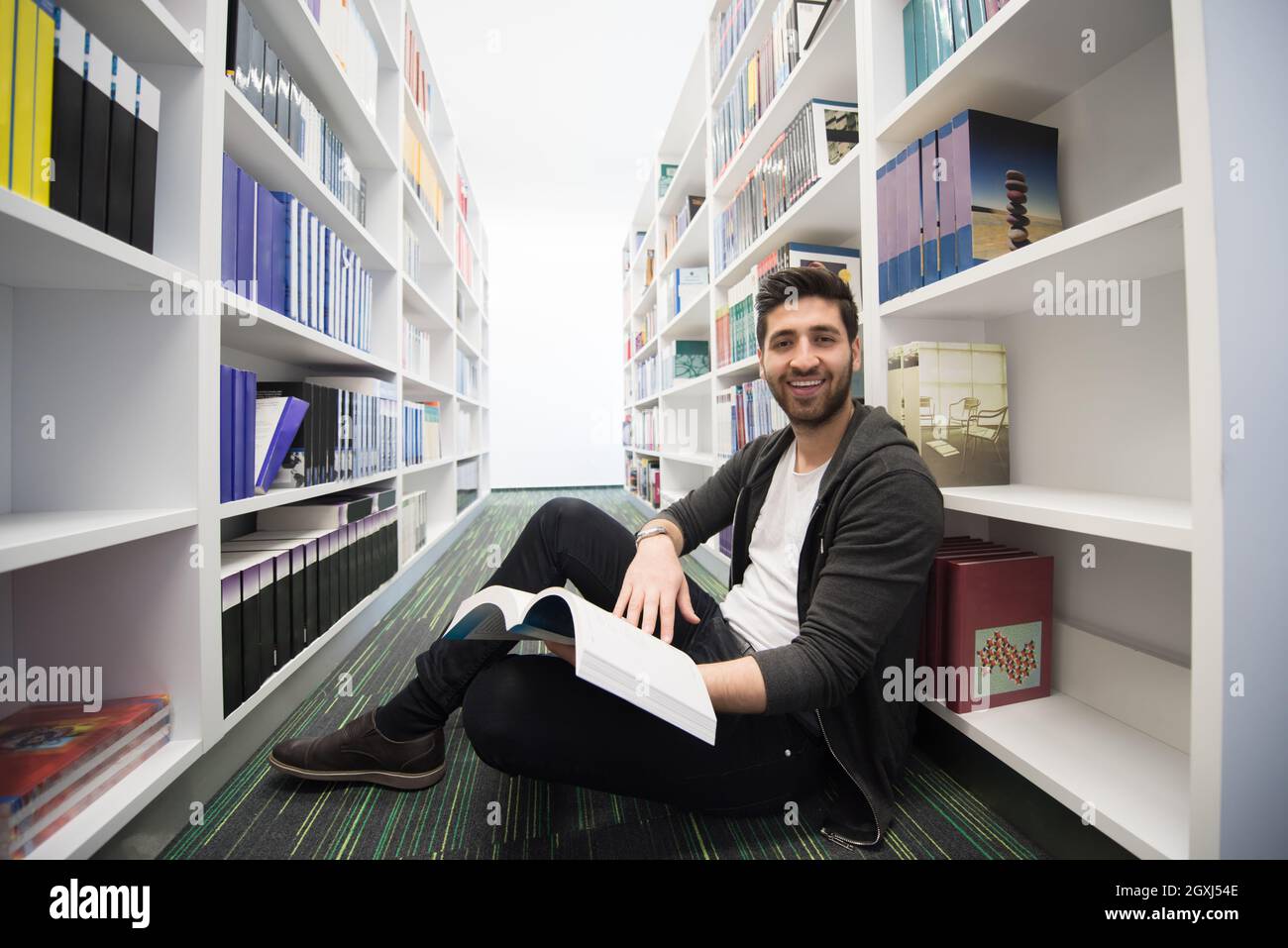 Student reading book in school library. Study lessons for exam. Hard ...