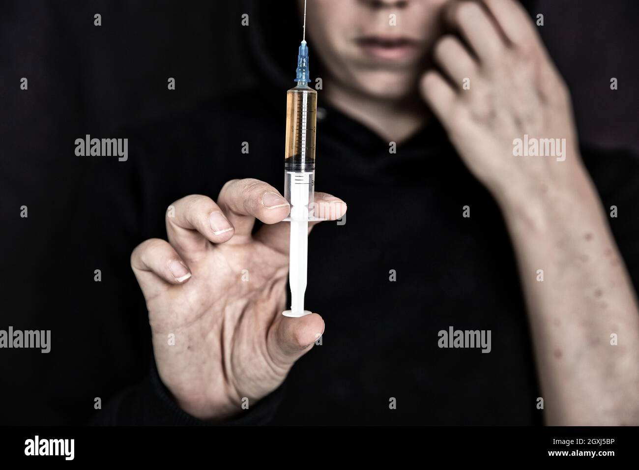 heroin addiction Junky shooting up Horse with syringe on dark ...