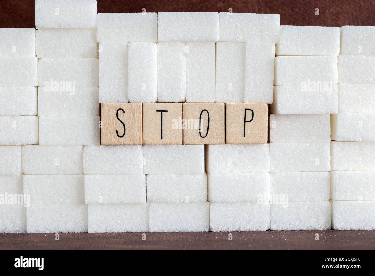 Pile or wall of sugar cubes and stop word in block letters as advise on ...