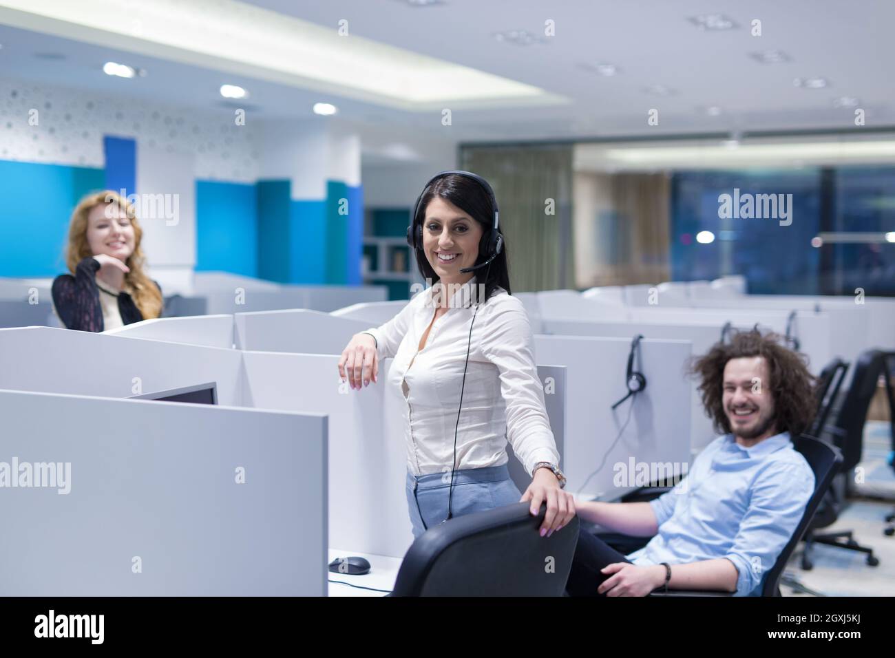 group of young business people with headset working and giving support ...
