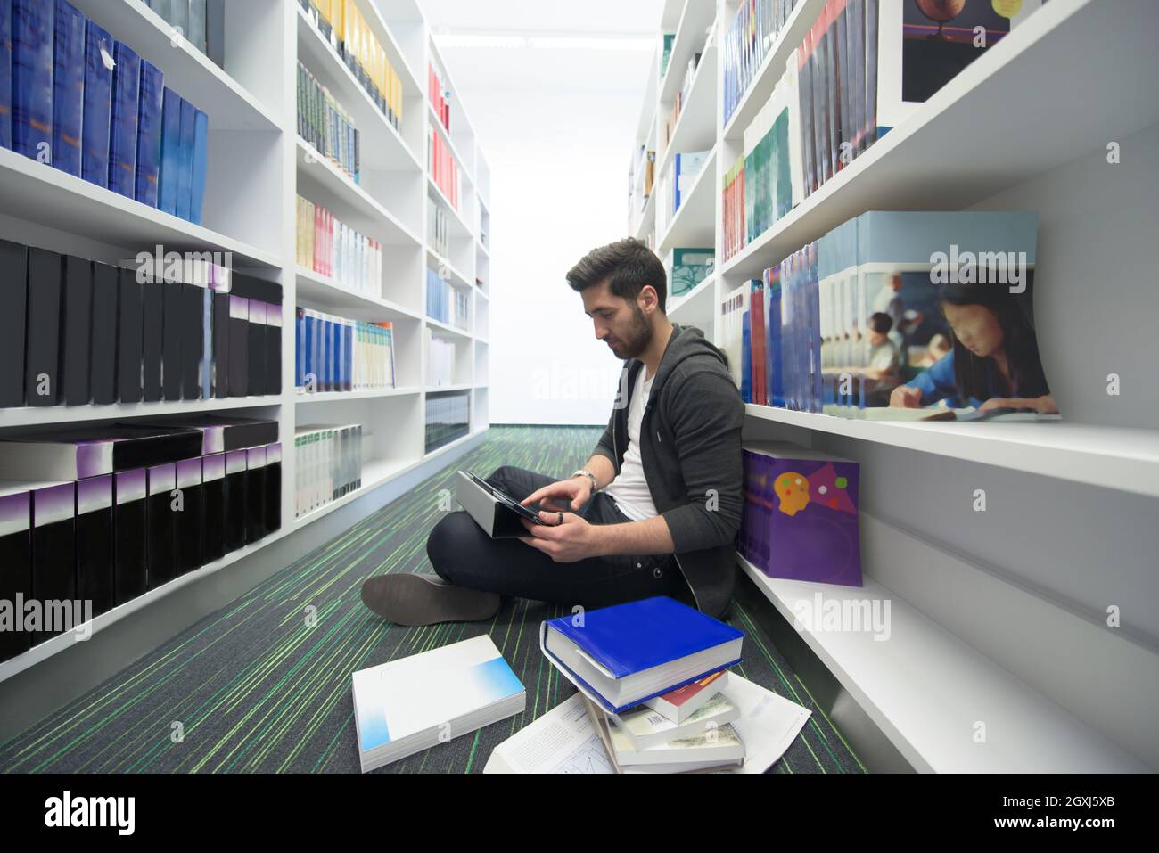 Student reading book in school library. Study lessons for exam. Hard ...