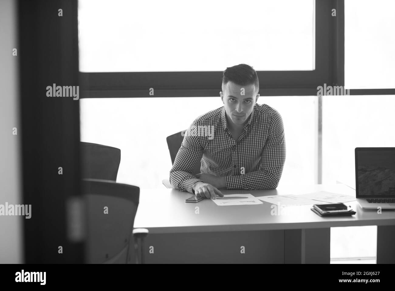 happy young businessman at his desk at work in modern startup business ...