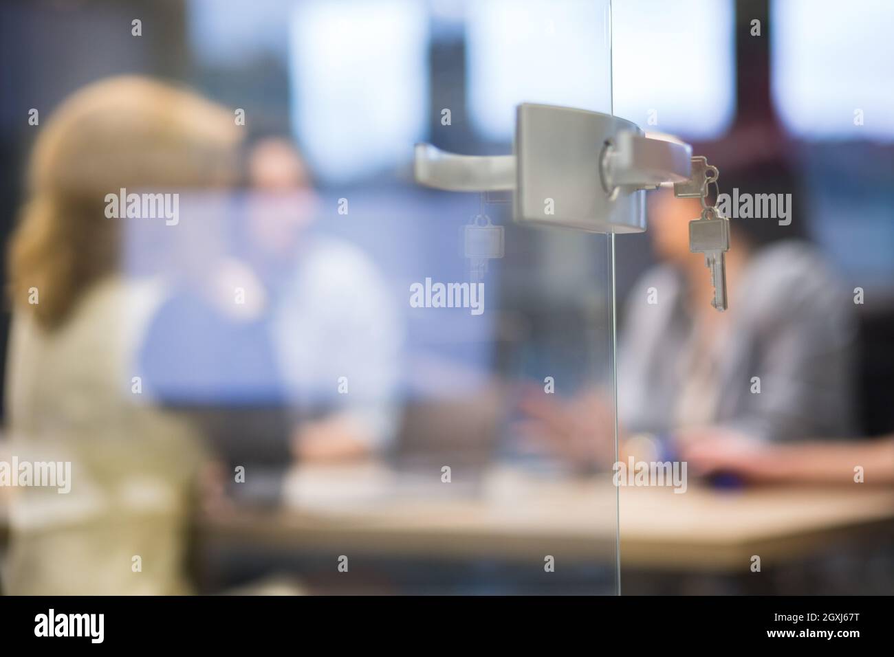 Open glass door with keys, key in keyhole Stock Photo - Alamy