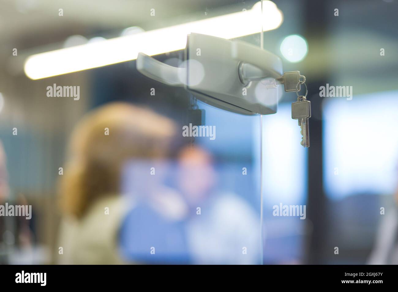 Open glass door with keys, key in keyhole Stock Photo - Alamy