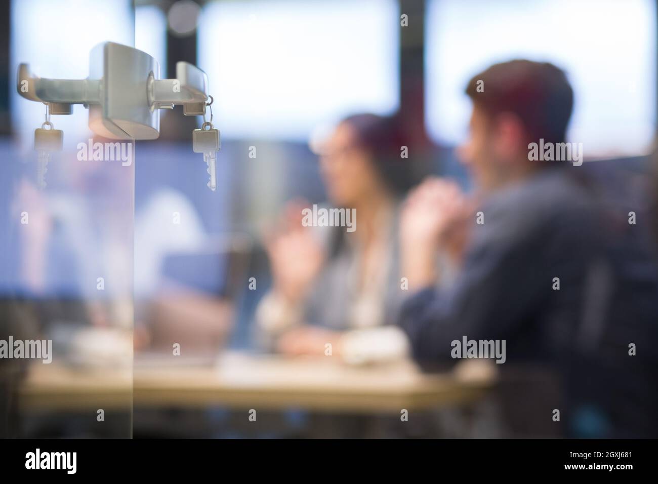 Open glass door with keys, key in keyhole Stock Photo - Alamy