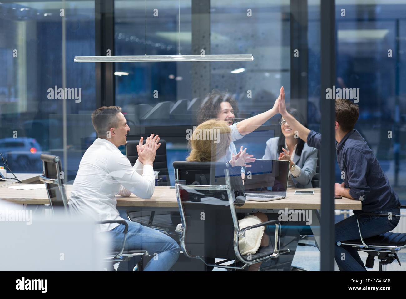 Group of young business people looking happy while celebrating success ...