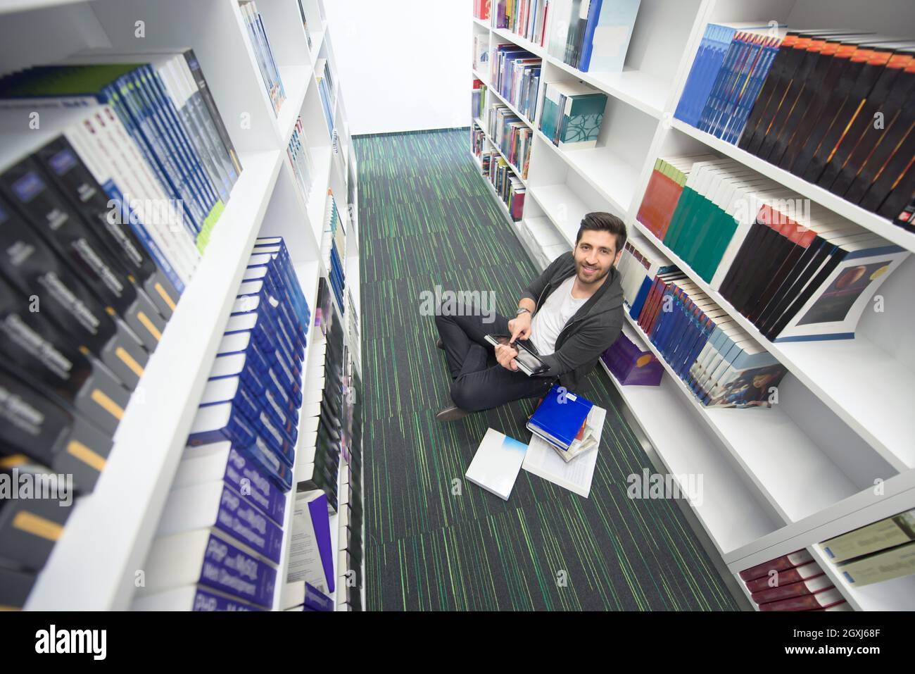 Student reading book in school library. Study lessons for exam. Hard ...