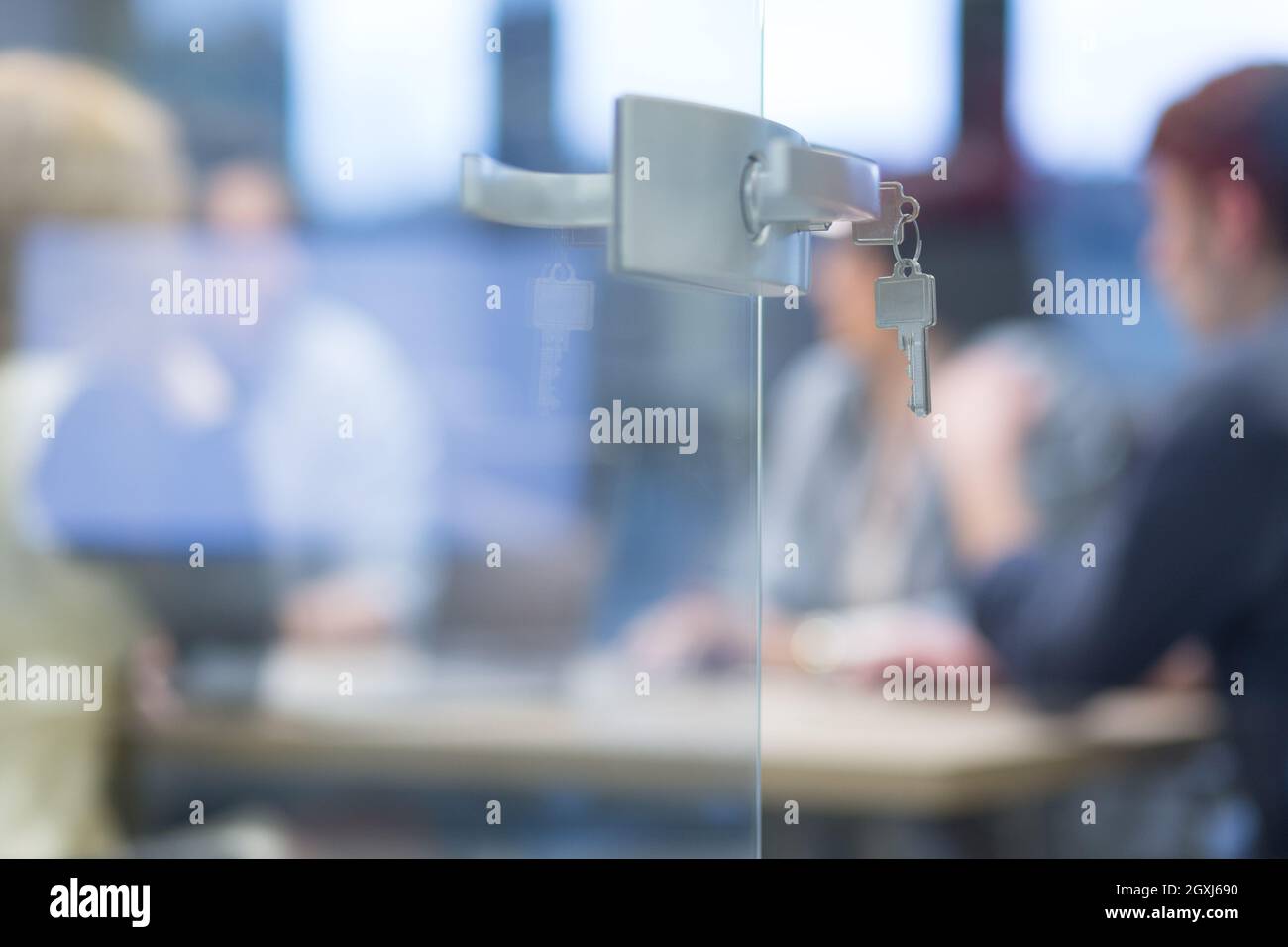 Open glass door with keys, key in keyhole Stock Photo - Alamy