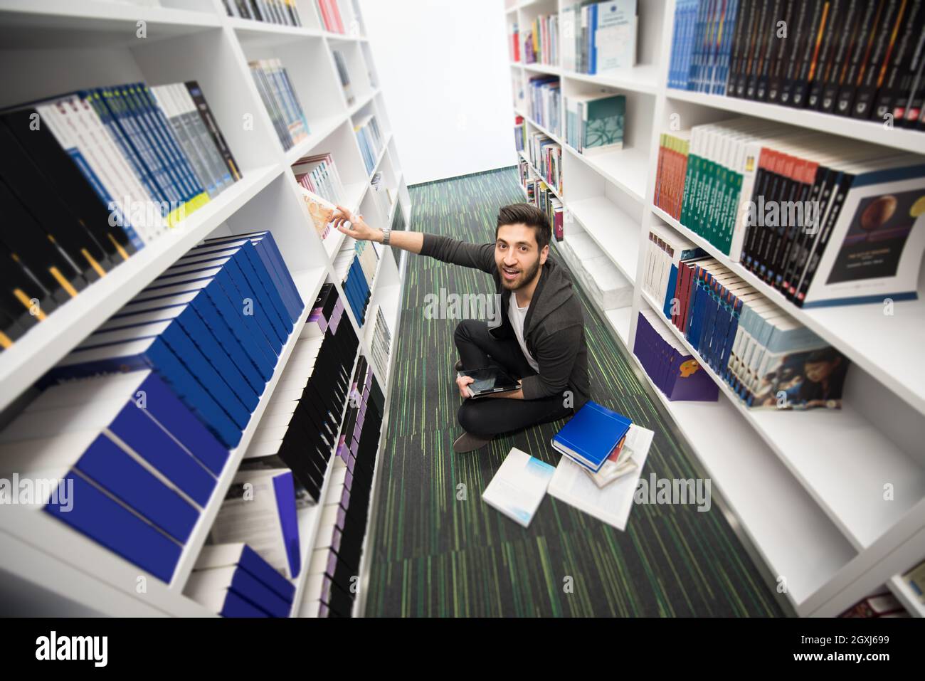 Student reading book in school library. Study lessons for exam. Hard ...