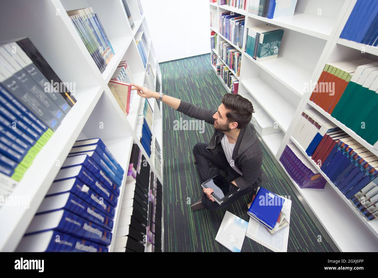 Student reading book in school library. Study lessons for exam. Hard ...