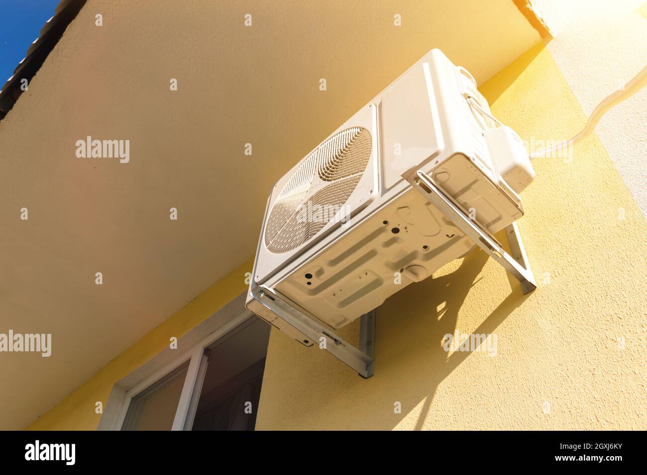 External air conditioner mounted outside on the house wall close-up ...
