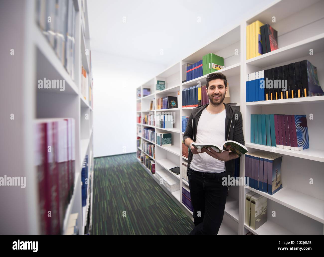 Student reading book in school library. Study lessons for exam. Hard ...