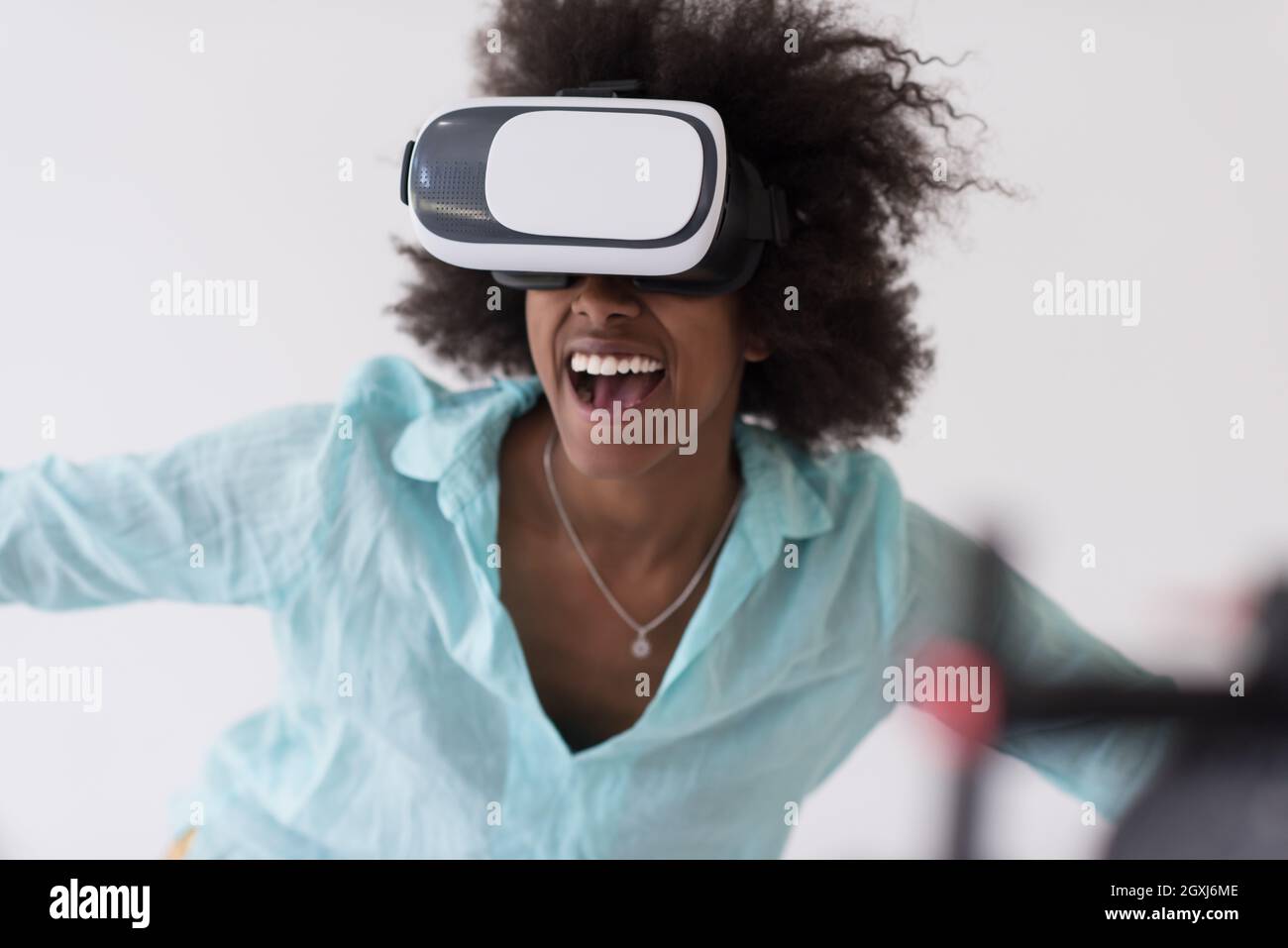 Happy african american girl getting experience using VR headset glasses ...