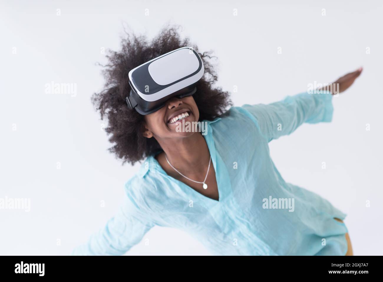 Happy african american girl getting experience using VR headset glasses ...