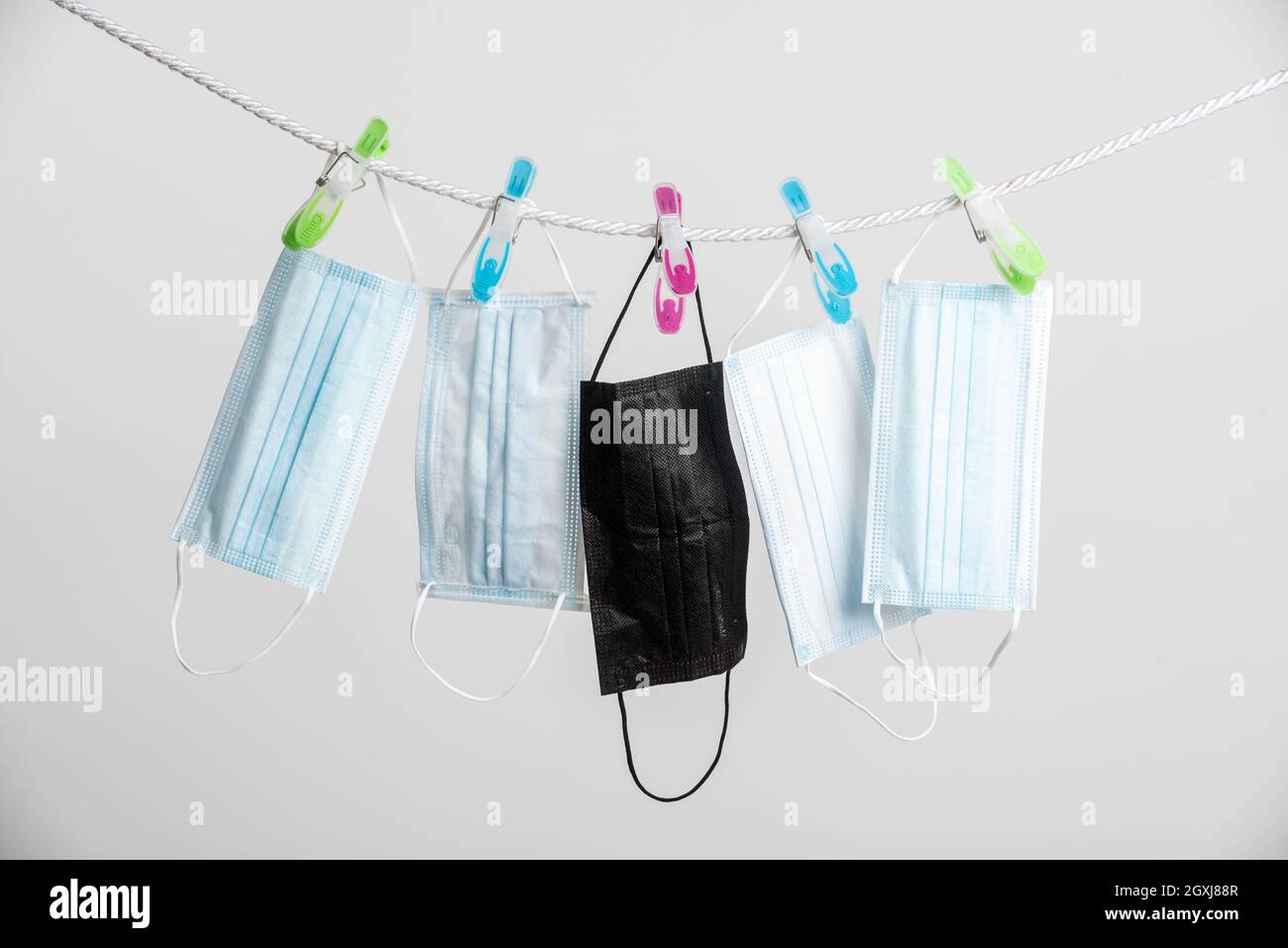 Surgical masks hanging with clothespins On white background Stock Photo ...