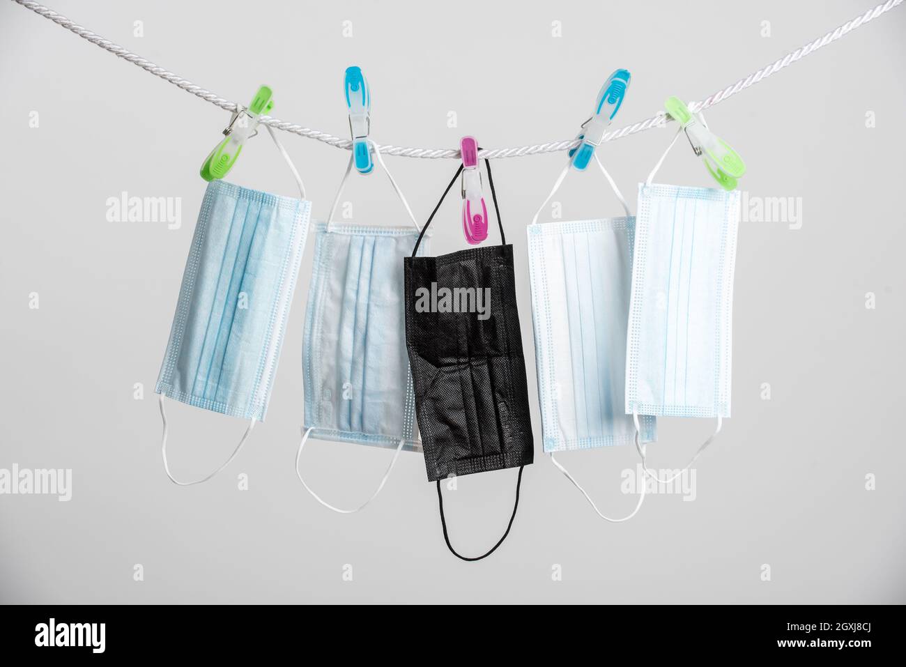 Surgical masks hanging with clothespins On white background Stock Photo ...