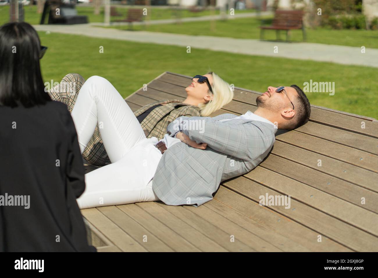 Three business co-workers are relaxing on their break from work Stock ...