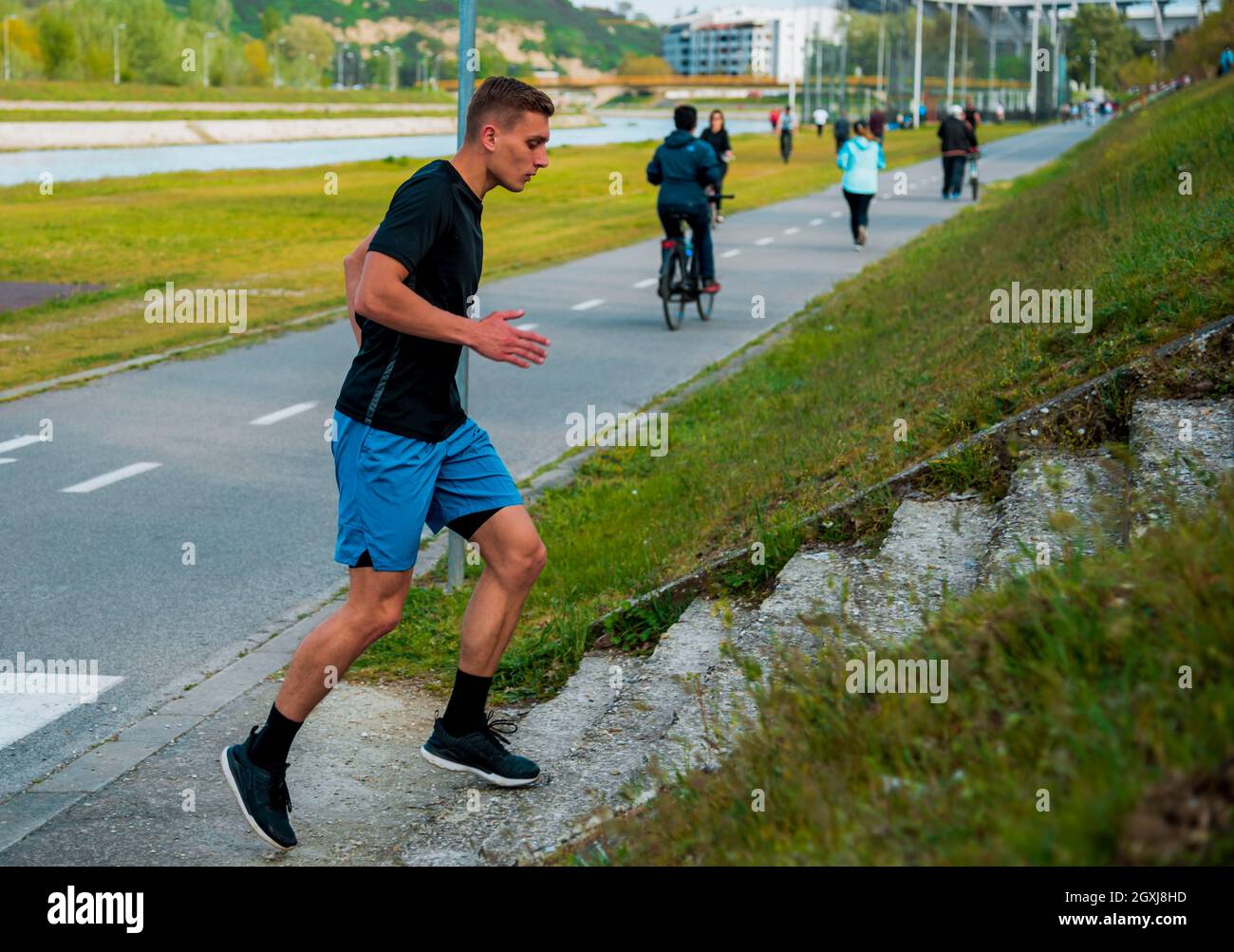Young man running upstairs on city stairs. Fitness, sport, people ...