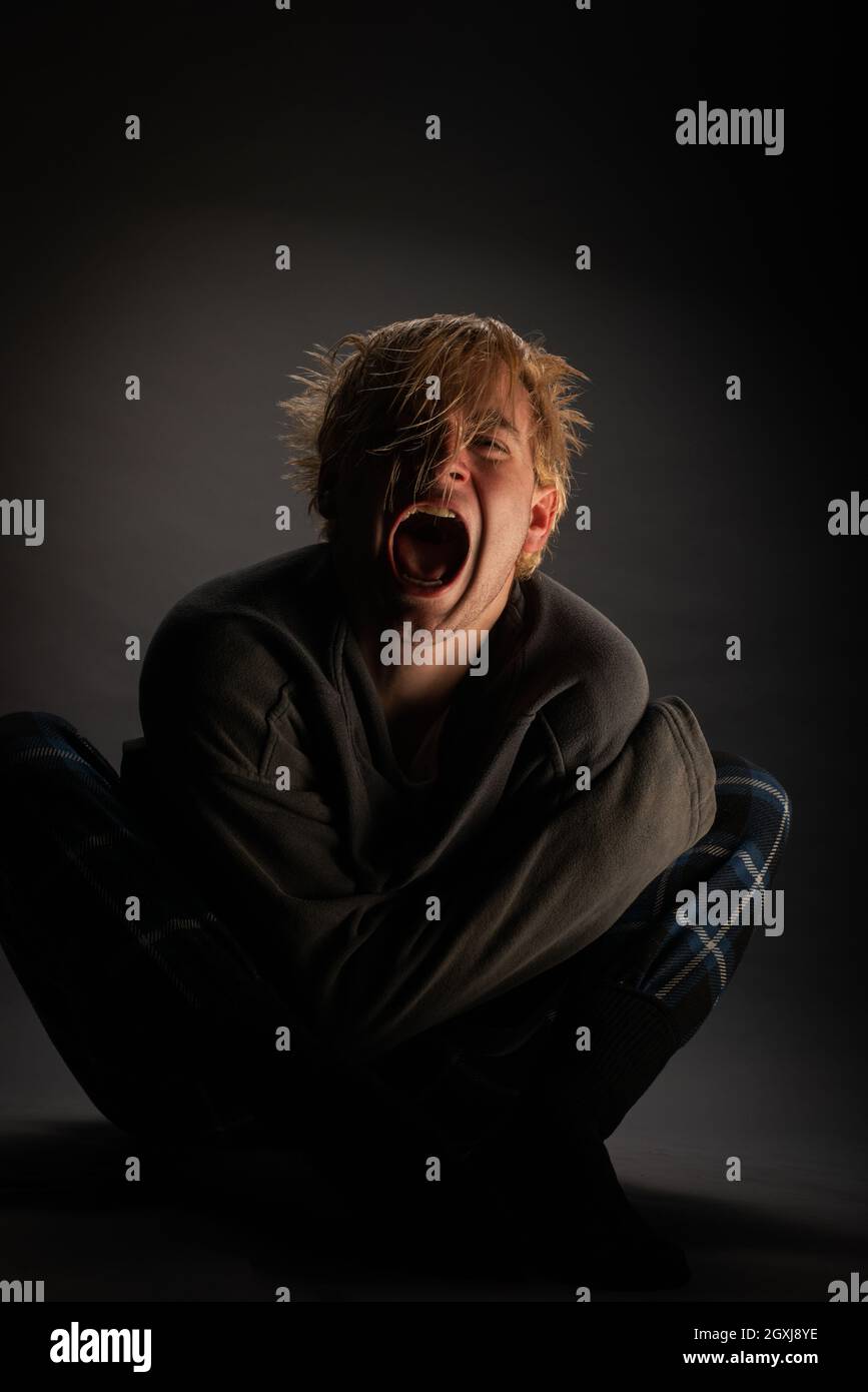 Broken boy is screaming with lot of anger and pain Stock Photo - Alamy