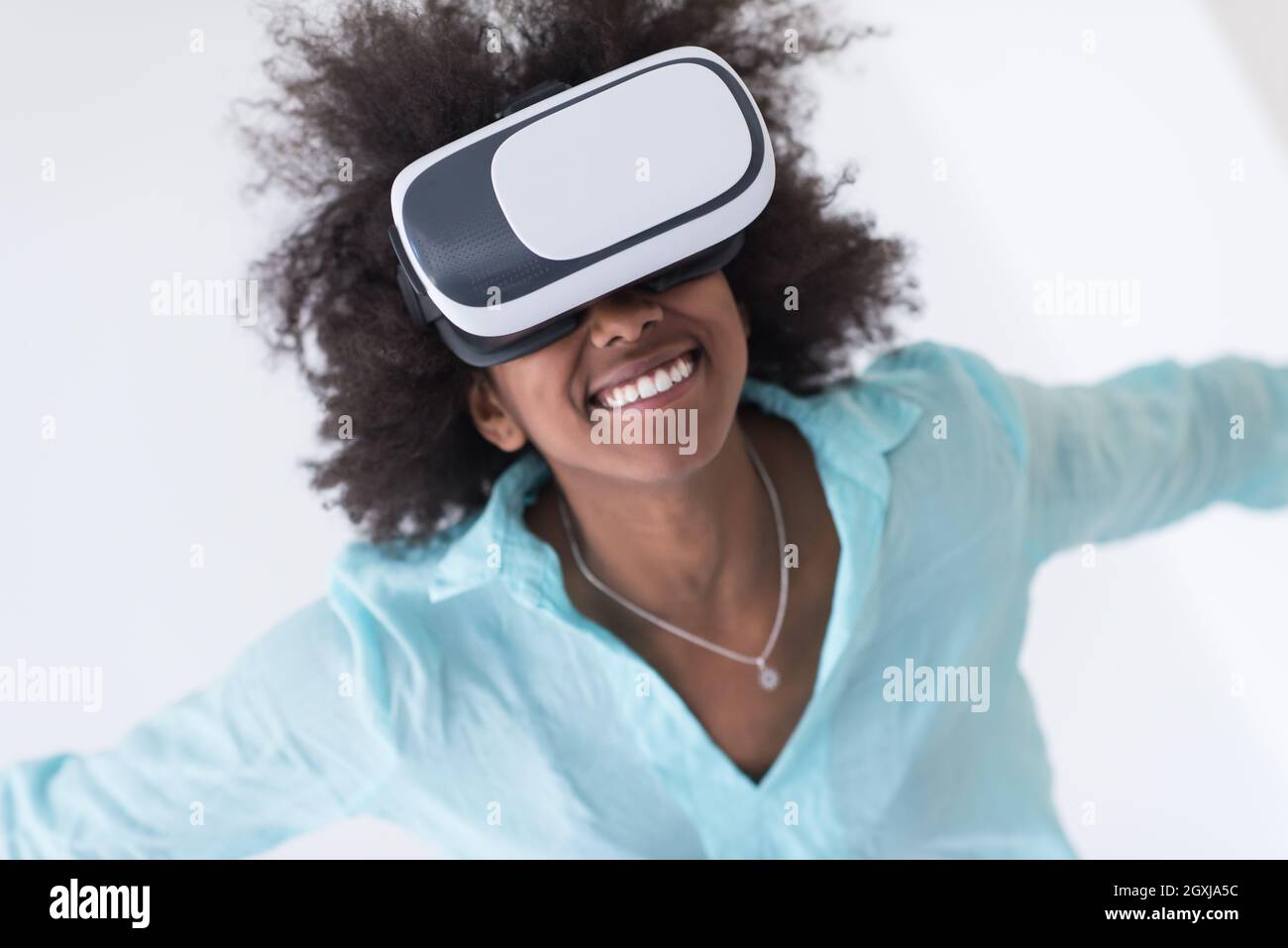 Happy african american girl getting experience using VR headset glasses ...