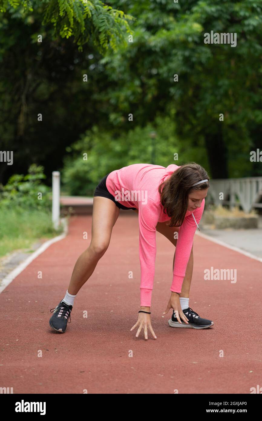 Beautiful young girl is getting ready to stretch before her morning ...