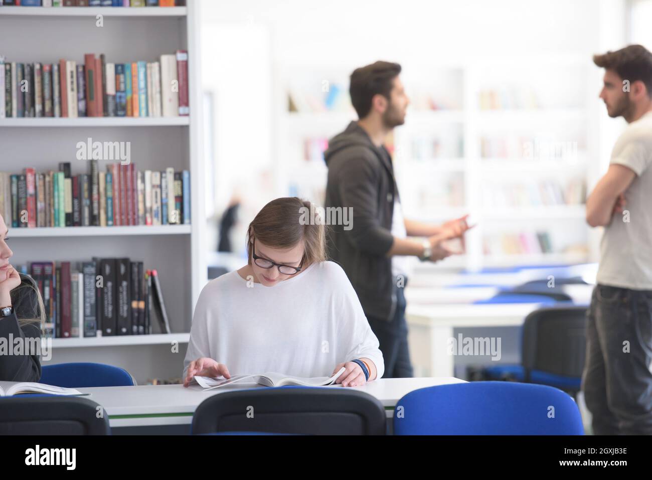 female smart looking student study in school library, group of students ...