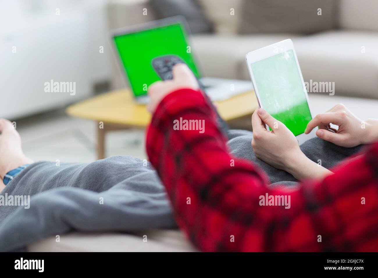 Young couple relaxing at home using tablet computers reading in the ...
