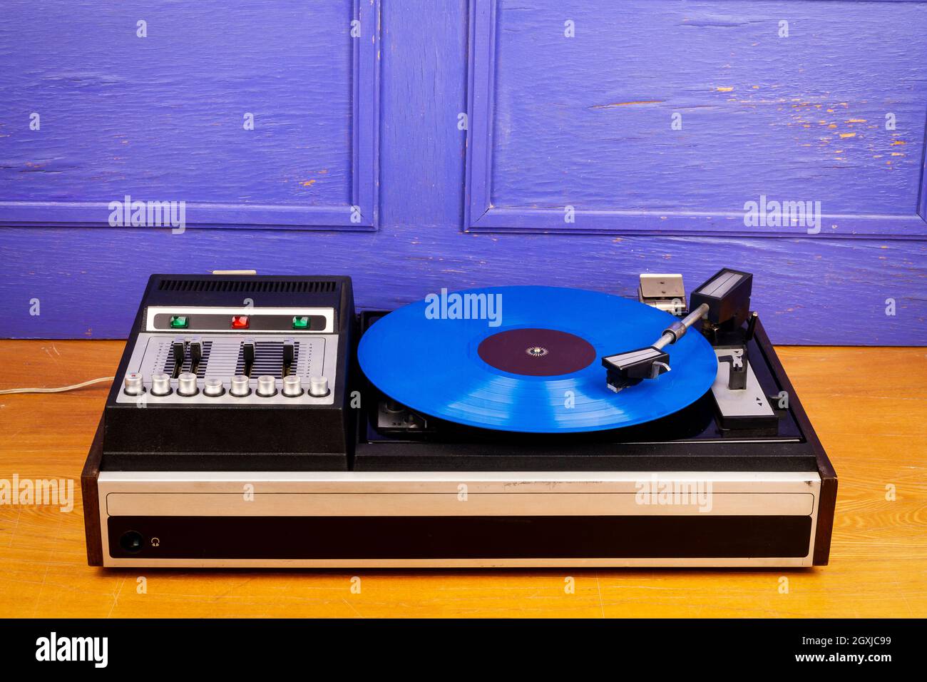 Vintage turntable vinyl record player with blue vinyl on a table Stock ...