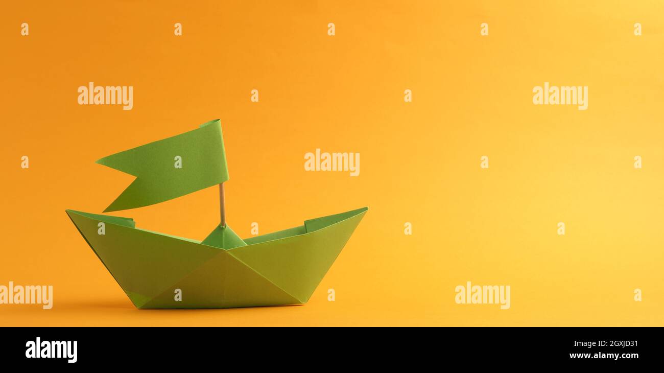 Green paper boat on a yellow background with space for text Stock Photo ...