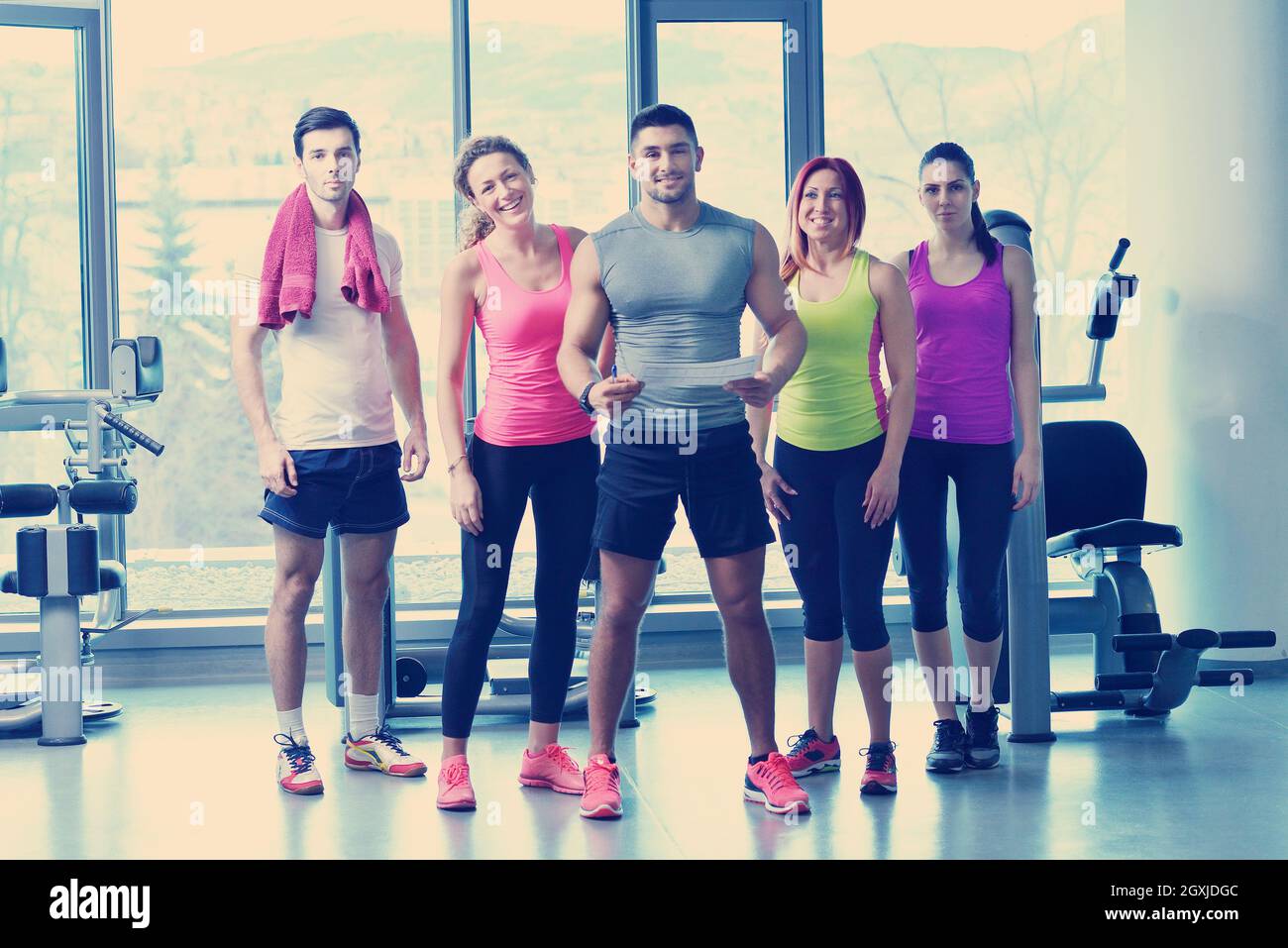 Group of people exercising at the gym and stretching Stock Photo - Alamy