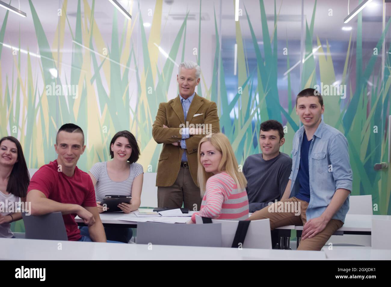 portrait of confident teacher, students group in background Stock Photo ...