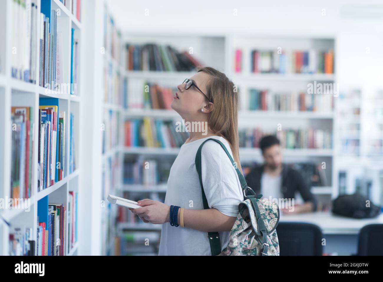 smart looking famale student girl in collage school library selecting ...